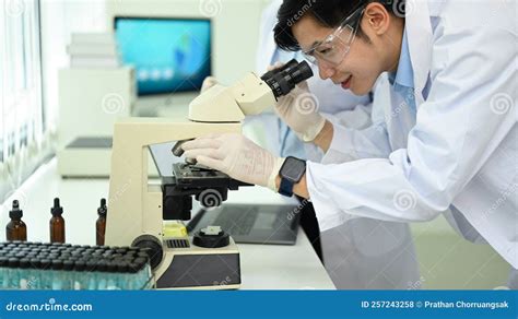 Professional Biotechnology Specialist Looking Under Microscope