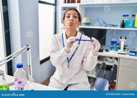 Young Brunette Woman Working At Scientist Laboratory Wearing Safety