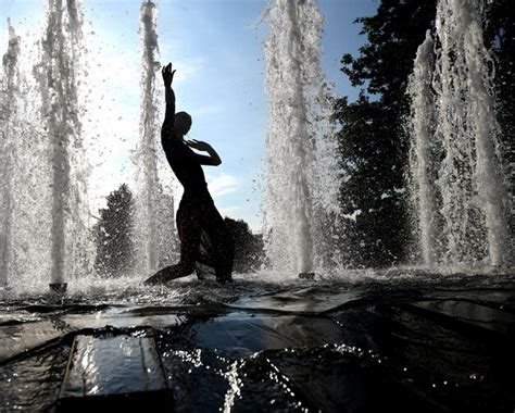 Premium Photo Silhouette Woman Dancing By Splashing Water In Fountain