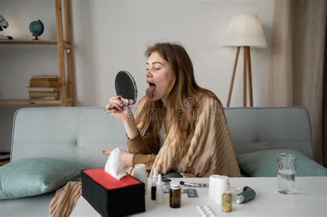 Sore Throat The Girl Holds A Mirror In Her Hands And Looks Into Her