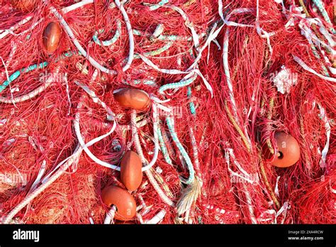 Red Fishing Net Orange Floats And Ropes In Daytime Stock Photo Alamy