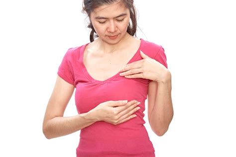Premium Photo Woman Touching Breast While Standing Against White