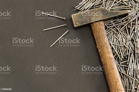 다른 금속 손톱과 복사 공간 왼쪽에 검은 배경에 오래 된 망치의 더미 목공의 개념으로 어두운 배경입니다 0명에 대한 스톡 사진