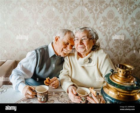 Elderly Senior Romantic Love Couple Drinking Tea With Cookies From