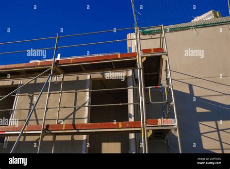 Home Construction Scaffolding And Constructionnew House In Scaffolding On Blue Sky Background