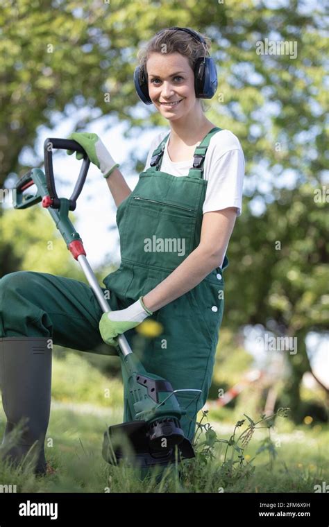 Woman Gardener Using String Lawn Trimmer Stock Photo Alamy