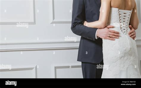 Elegant Bride And Groom Posing Together In Studio On A Wedding Day