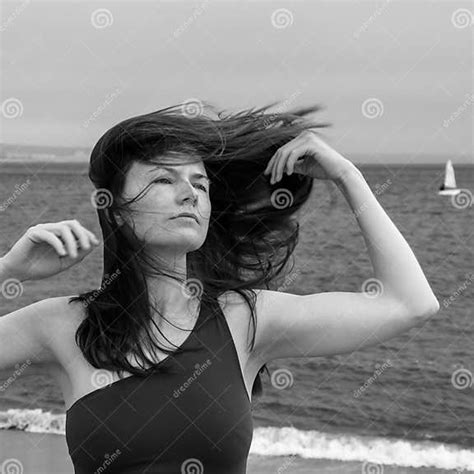 Black And White Portrait Of A Beautiful Woman With Wind In Her Hair