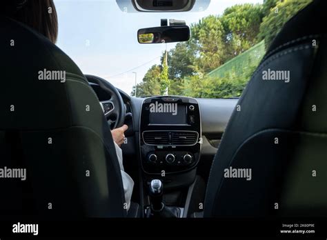 Woman Driving View From The Back Seat At A Low Angle To The Car Main