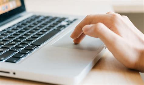 Premium Photo A Person Using A Trackpad On Laptop