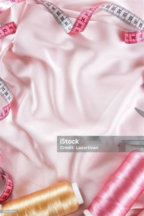핑크 실크 직물 실크 원사 바느질 과정 센티미터 가 위 및 분홍색 직물에 스레드 화려한 노란색과 분홍색 스레드 평면도 가위에