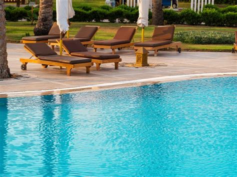 Beach Lounger Sun Lounger Near The Pool With Turquoise Water Stock