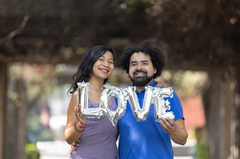 Premium Photo Mexican Young Couple Holding Love Balloon