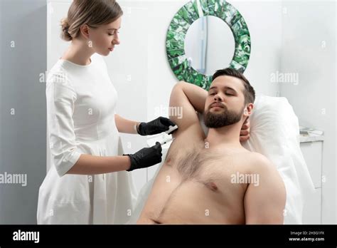 Doctor Doing Injection From Hyperhidrosis Man Receiving An Underarm Treatment In Cosmetology