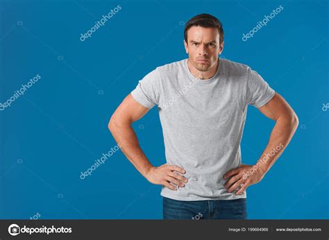 Frowning Man Standing Hands Waist Looking Camera Isolated Blue Stock