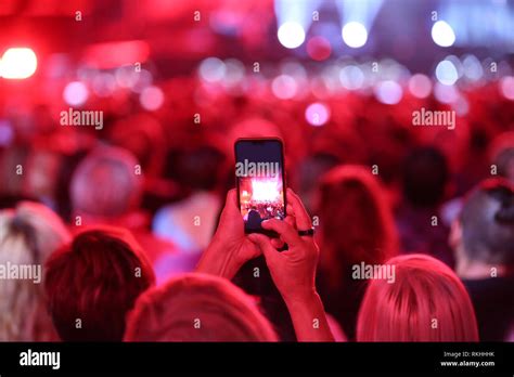 Woman With Smartphone During A Live Concert With A Lot Of People Stock