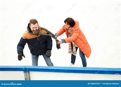 Middle Aged Couple Man And Woman Having Fun Outdoors Skating On Open