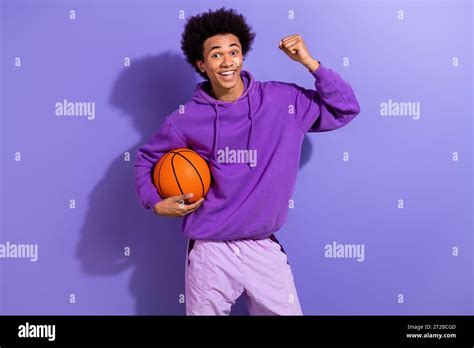 Portrait Of Delighted Excited Person Hand Hold Basketball Raise Fist
