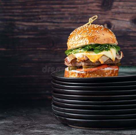Close Up Shot Of A Juicy Burger Placed On A Several Plates Stock Photo Image Of Seeds Tasty