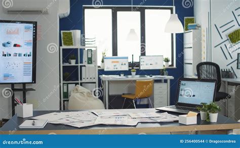 Empty Startup Office With Laptop Showing Analytics On Display With