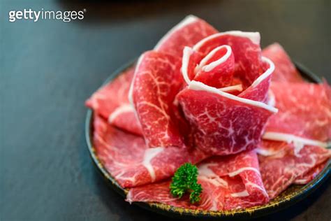 Sliced Wagyu Marbled Beef For Yakiniku On Plate On Black Background