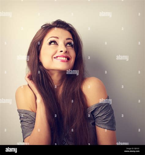 Thinking fun cute teen girl looking up with natural emotion on empty ...