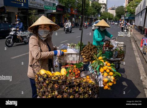 Street Vendors Plying Their Trade Around A Busy City Streets Of Ho Chi