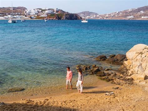 Premium Photo Man And Woman On The Beach Of Mykonos Island In Greece