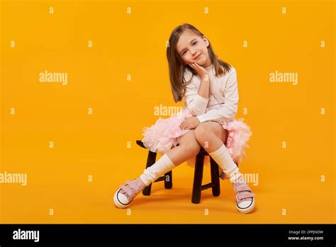 Lovely Young Girl Sitting On Small Wooden Chair In Tulle Skirt White