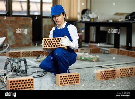 Female Builder Preparing Bricks For Erection Of Partition Wall Stock Photo Alamy