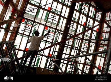 Figure Inside Timber Framed Building Clad Completely With Plastic On Construction Site Stock