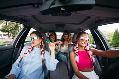 Premium Photo Fashionable Girlfriends Riding In Car And Having Fun