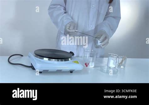 Scientist Demonstrates Sodium Acetate Crystallization Process Stock