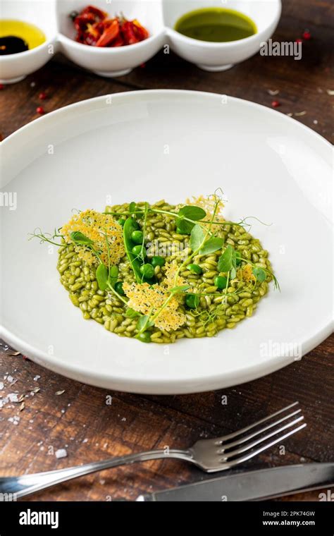 Pea Risotto On A White Porcelain Plate In A Fine Dining Restaurant