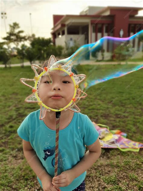 Premium Photo Portrait Of Cute Girl Holding Bubble Wand