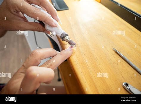 Close Up Photo Of A Woman Removing The Semi Permanent Nail Polish From