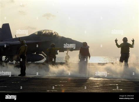 Us Navy Aircraft Directors Signal An F A 18f Super Hornet Assigned To Strike Fighter Squadron