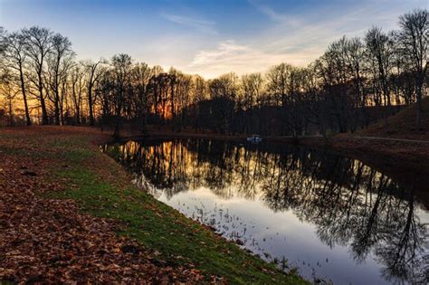 Premium Photo Pond In The Park With Trees Reflection From A Beautiful Sunset
