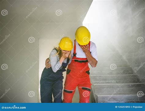Woman And Man Workers Suffocating At The Construction Site Stock Image