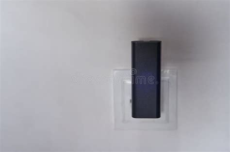 A Black Wi Fi Router Is Connected To A White Outlet On A White Wall Stock Image Image Of