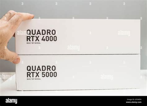 Male Hand On The Packaging Of Two New Gpu Nvidia Quadro Rtx 4000 And