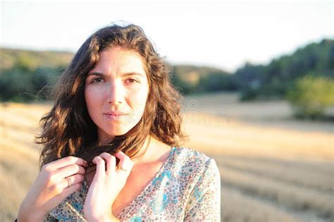 Portrait Of Young Beautiful Girl In A Wheat Field In The Afternoon