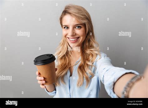 Photo Of Adorable Blond Businesswoman Smiling And Holding Paper Cup Of
