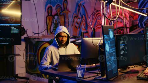 Hacker Arriving With Laptop In Hidden Base Deploying Viruses On