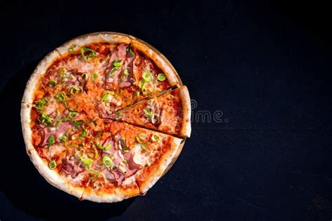 Delicious Pizza With Mozzarella Cheese Ham Leeks On A Tomato Base On