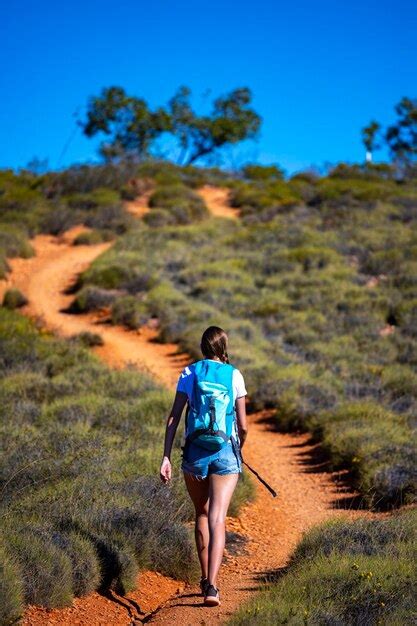 Premium Photo Fit Girl With Backpack Hiking Uphill On Red Rocks In