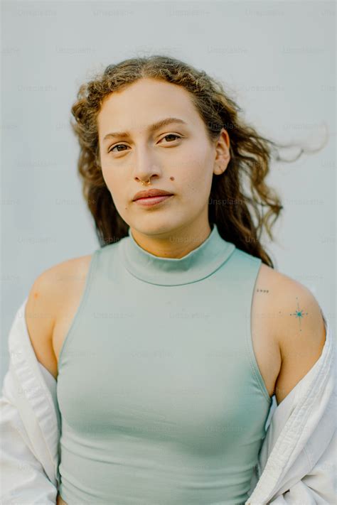 A Woman With A Tattoo On Her Arm Photo Fashion Image On Unsplash