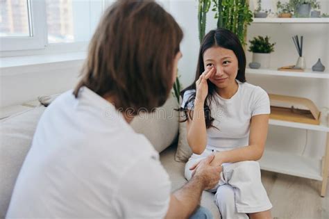 An Asian Woman Is Sad And Crying With Her Male Friend At Home Stress