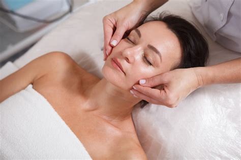 Premium Photo Top View Shot Of A Professional Masseuse Massaging Face