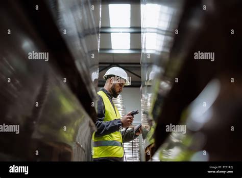 Warehouse Worker Holding Scanner Scanning The Barcodes On Products In Warehouse Warehouse
